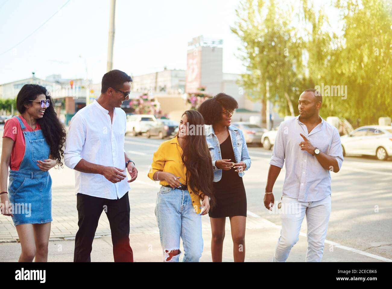 College students walking together outdoors. Young beautiful people of ...