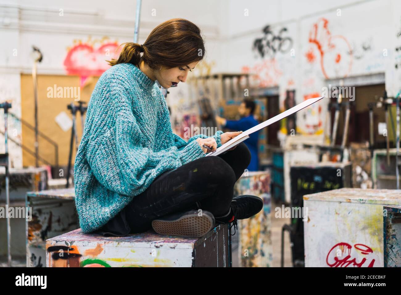 Woman creating drawing in studio Stock Photo - Alamy