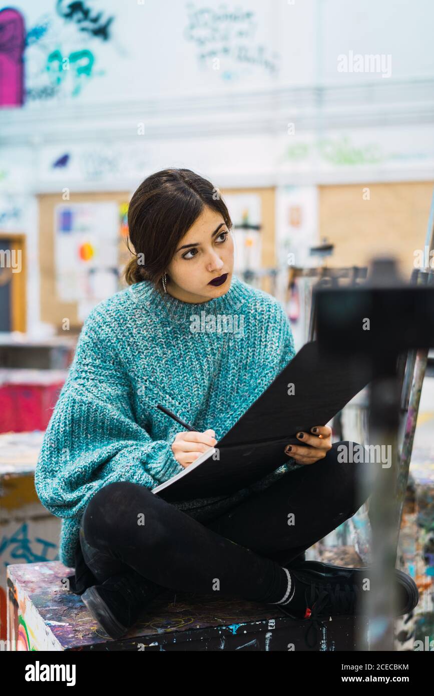 Woman creating drawing in studio Stock Photo - Alamy