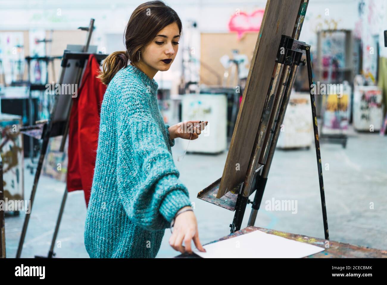 Woman creating drawing in studio Stock Photo - Alamy