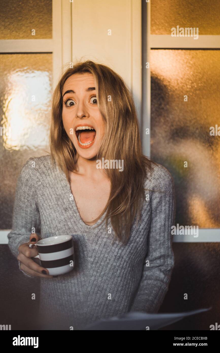 Shocked Woman with papers Stock Photo - Alamy