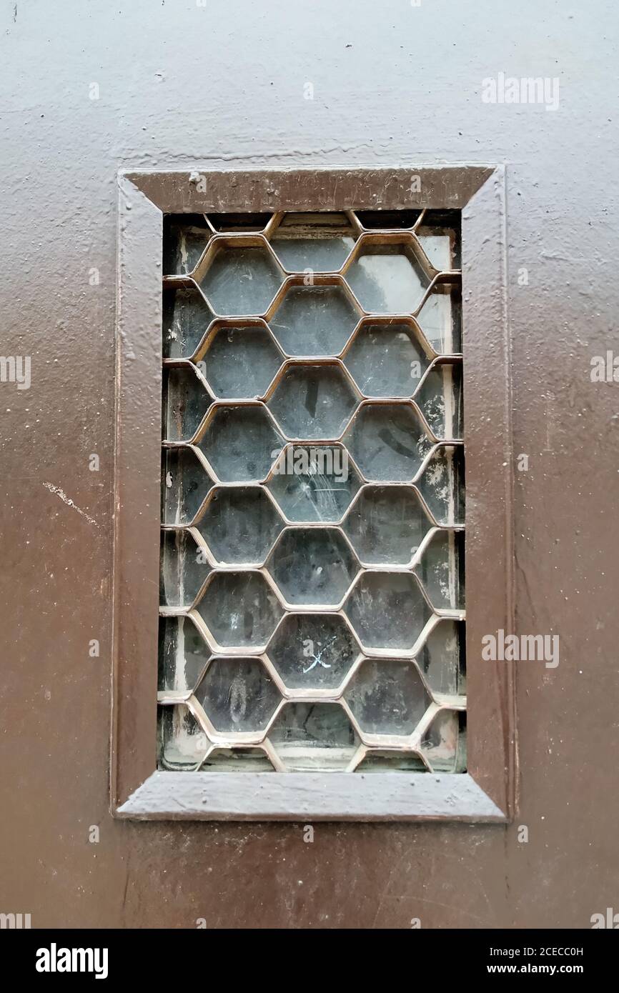 Window on an old dirty metal door Stock Photo - Alamy
