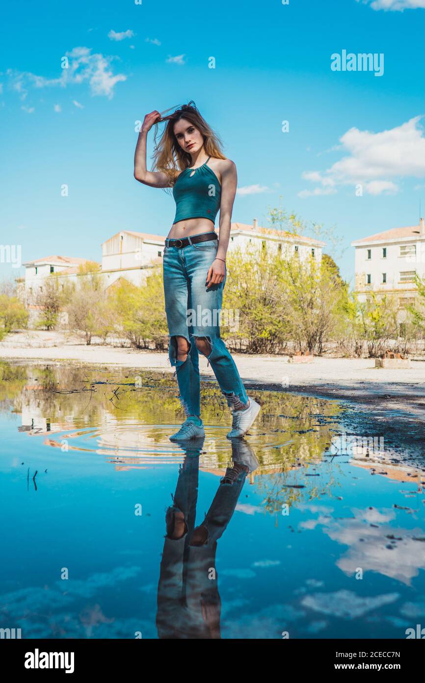 girl posing above puddle Stock Photo - Alamy