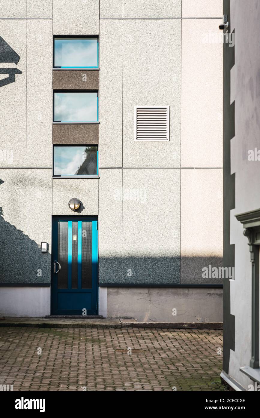 Brick path located near entrance of nice modern building on city street ...