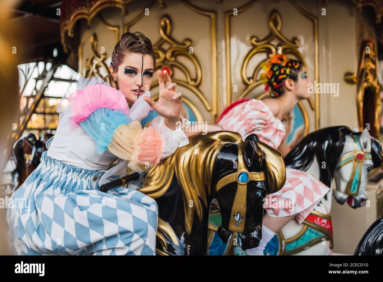 Two pretty young women with theatrical makeup and costumes laughing ...