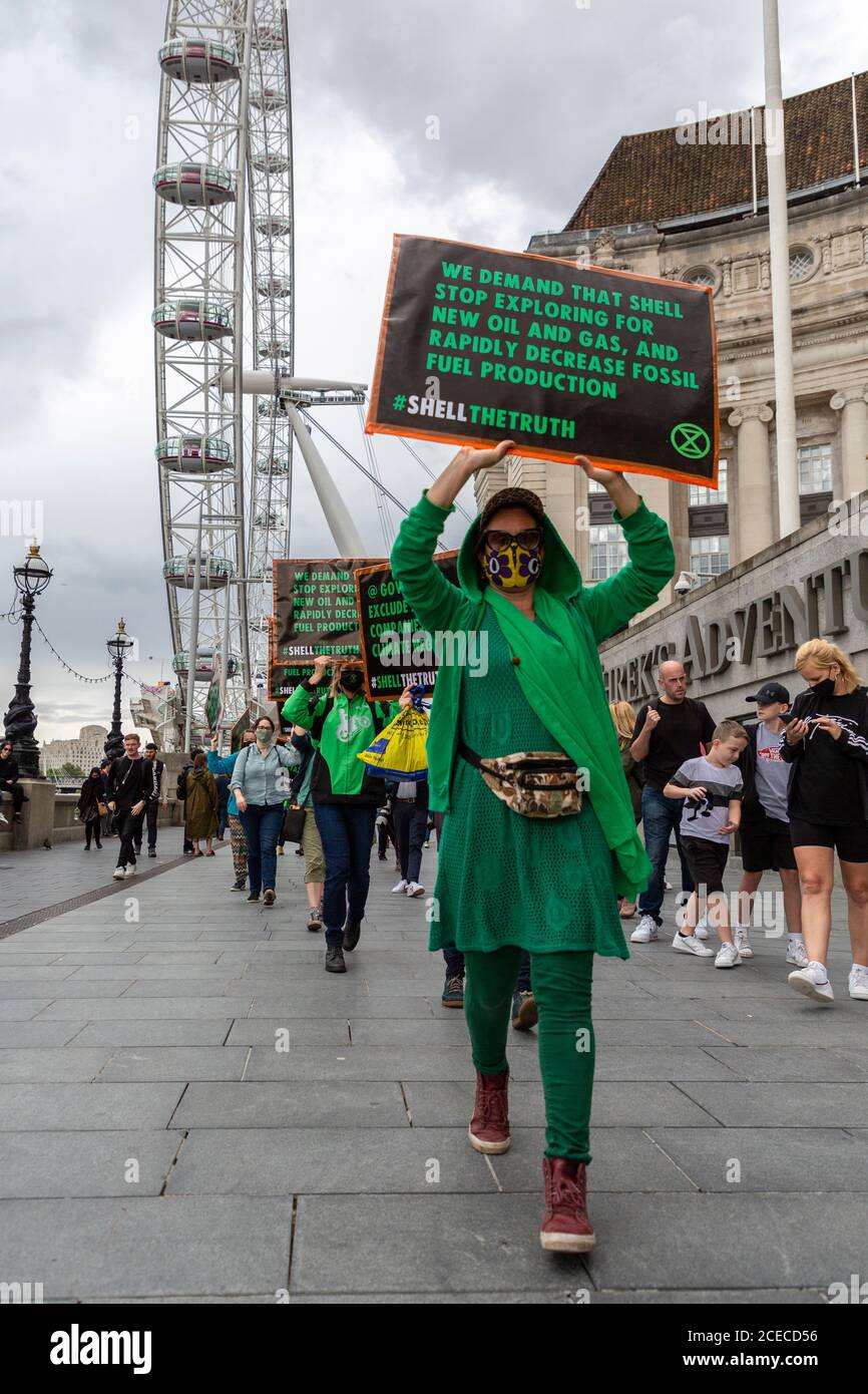 Protesters walk beside the London Eye, Extinction Rebellion ...