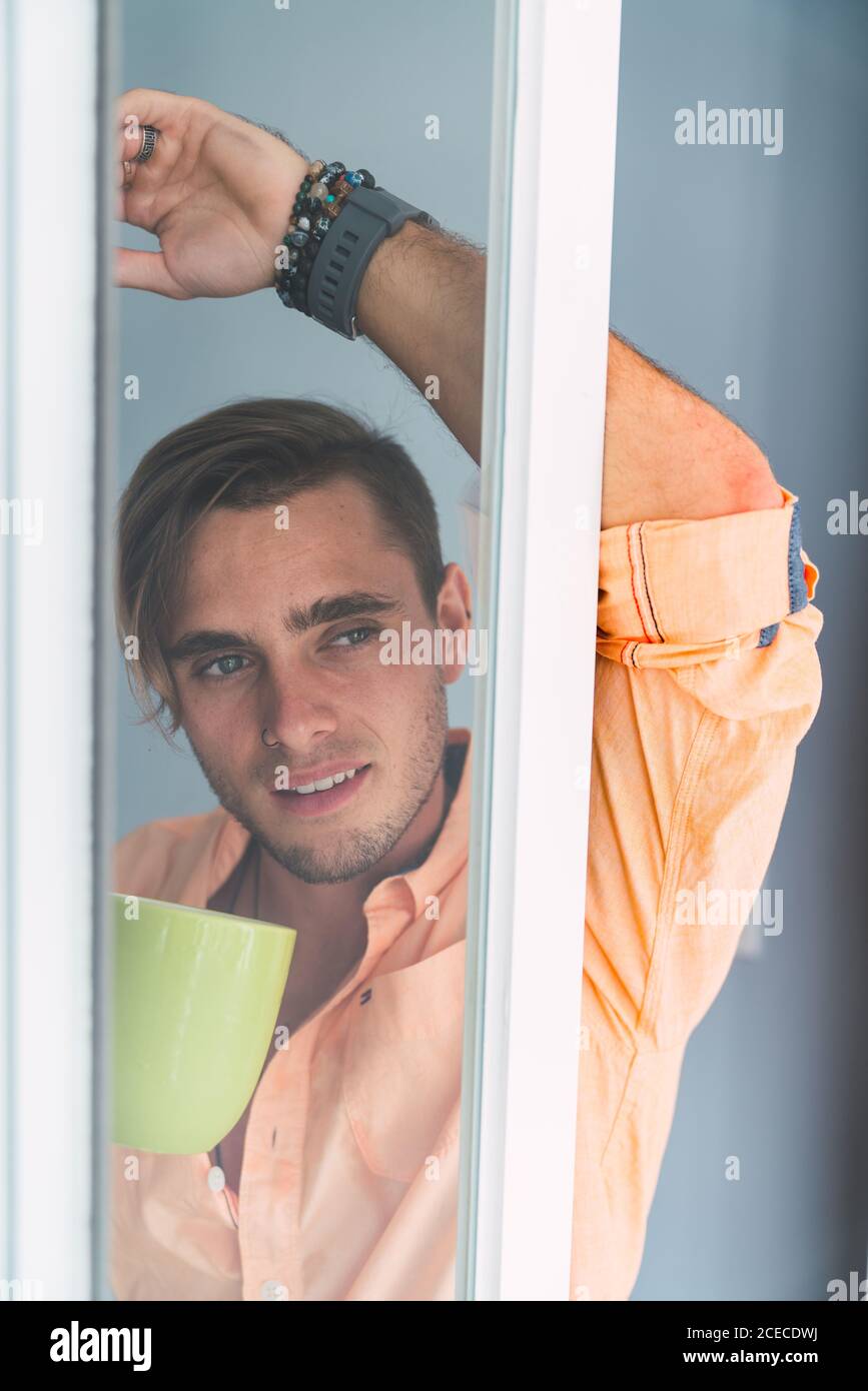 Man leaning on window High Resolution Stock Photography and Images - Alamy