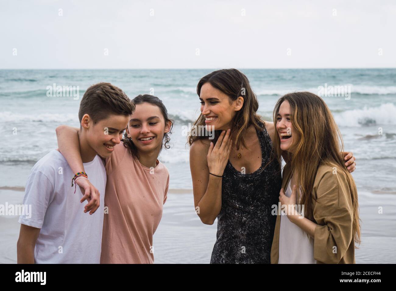 Group of friends hugging at the beach hi-res stock photography and ...