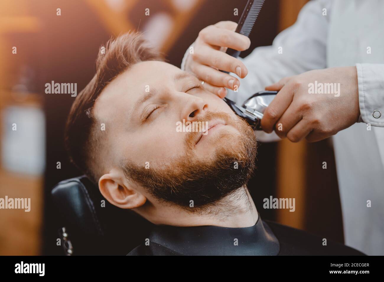 Barber busy grooming beard hi-res stock photography and images - Alamy