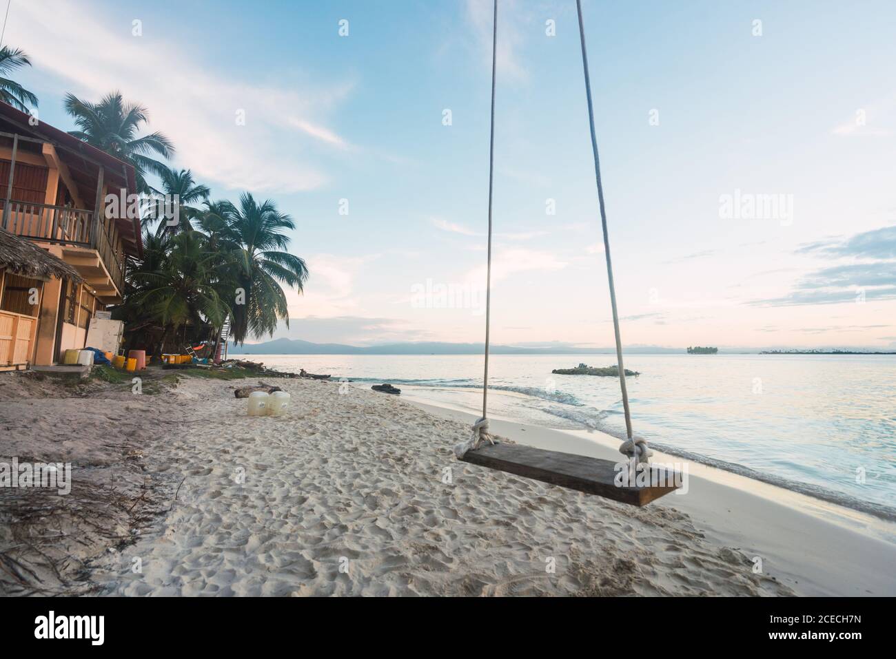 Swing hanging on palm hi-res stock photography and images - Alamy