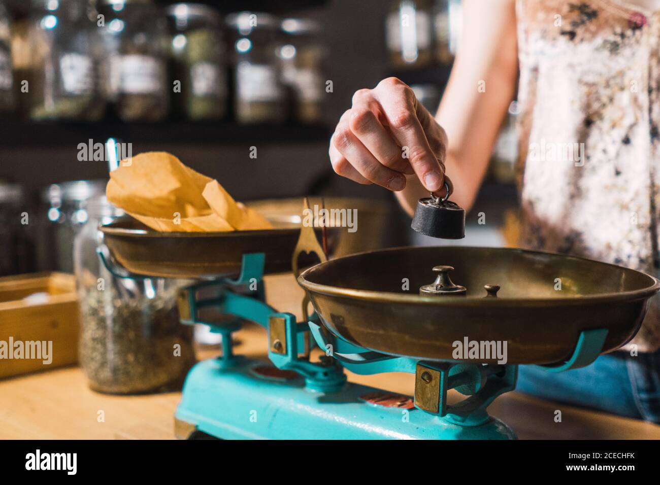 Small weight putting on scales indoors Stock Photo - Alamy