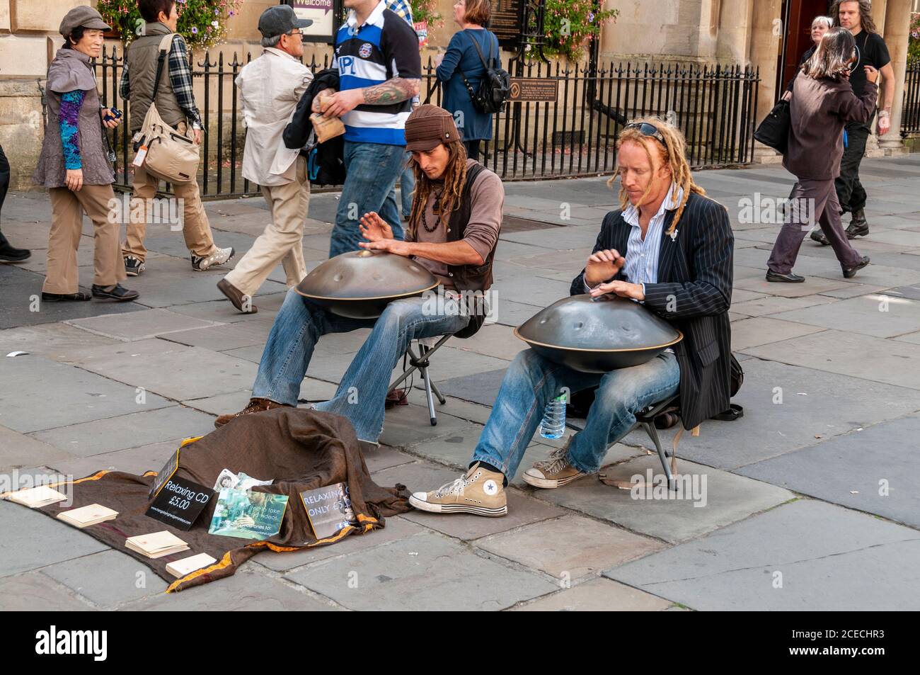 A couple of street buskers with their musical instruments playing to ...