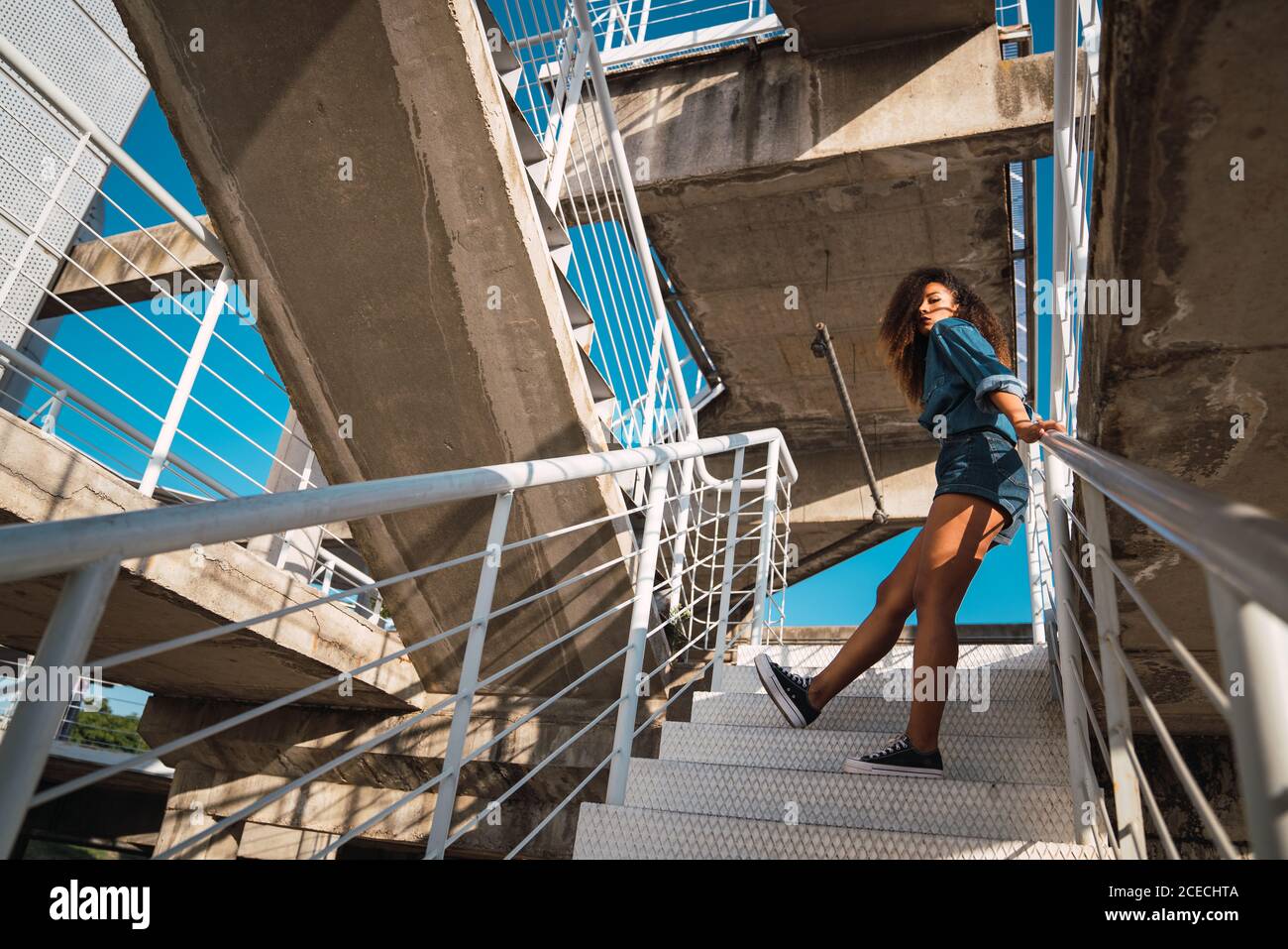 Young Woman going downstairs Stock Photo - Alamy
