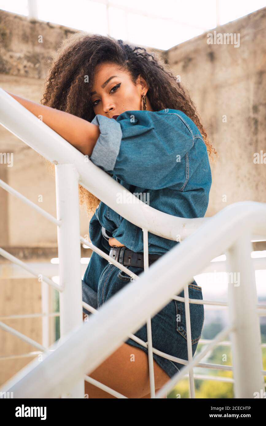 Woman standing by wall hi-res stock photography and images - Alamy