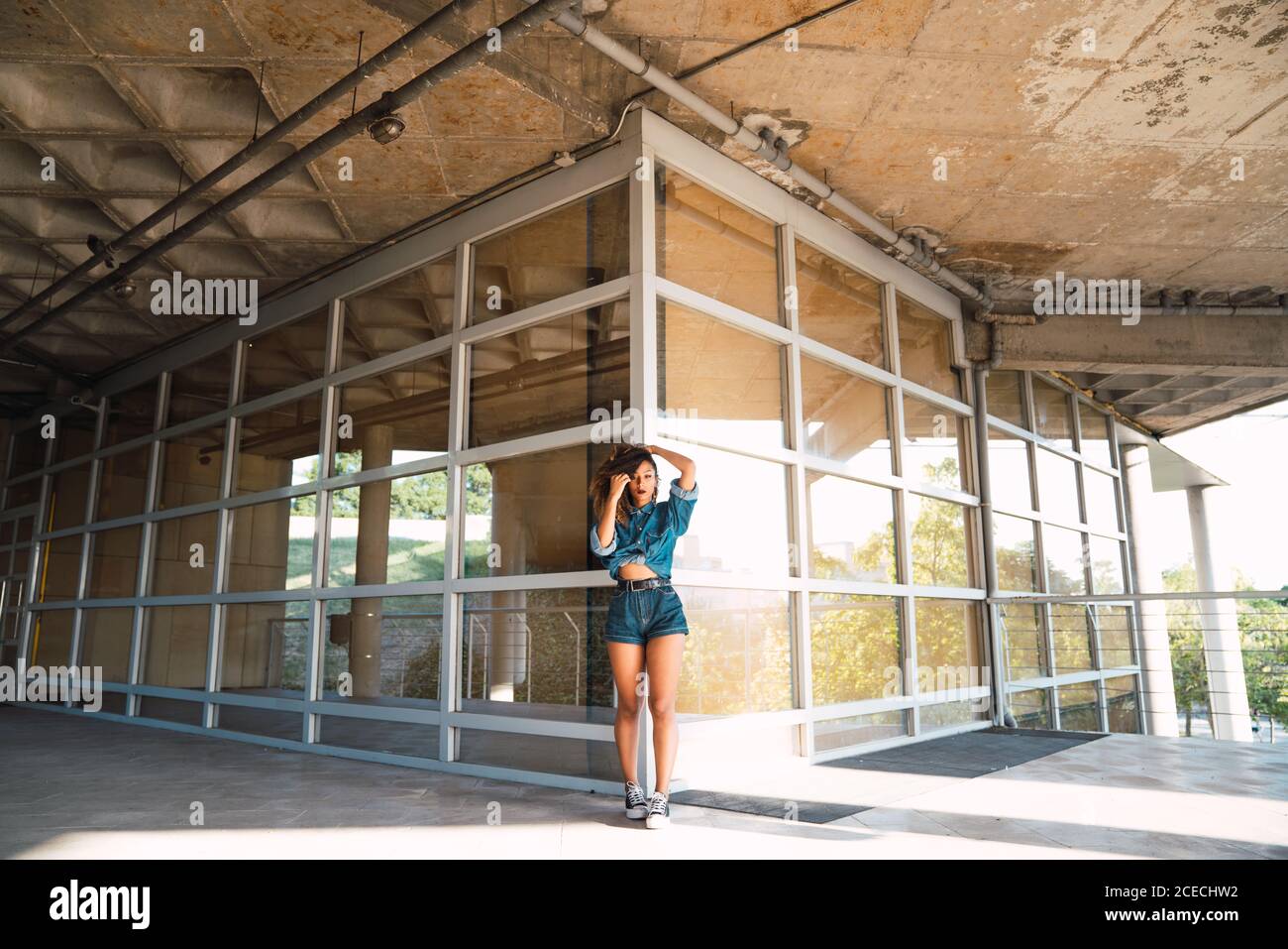 African-American Woman standing near wall Stock Photo - Alamy