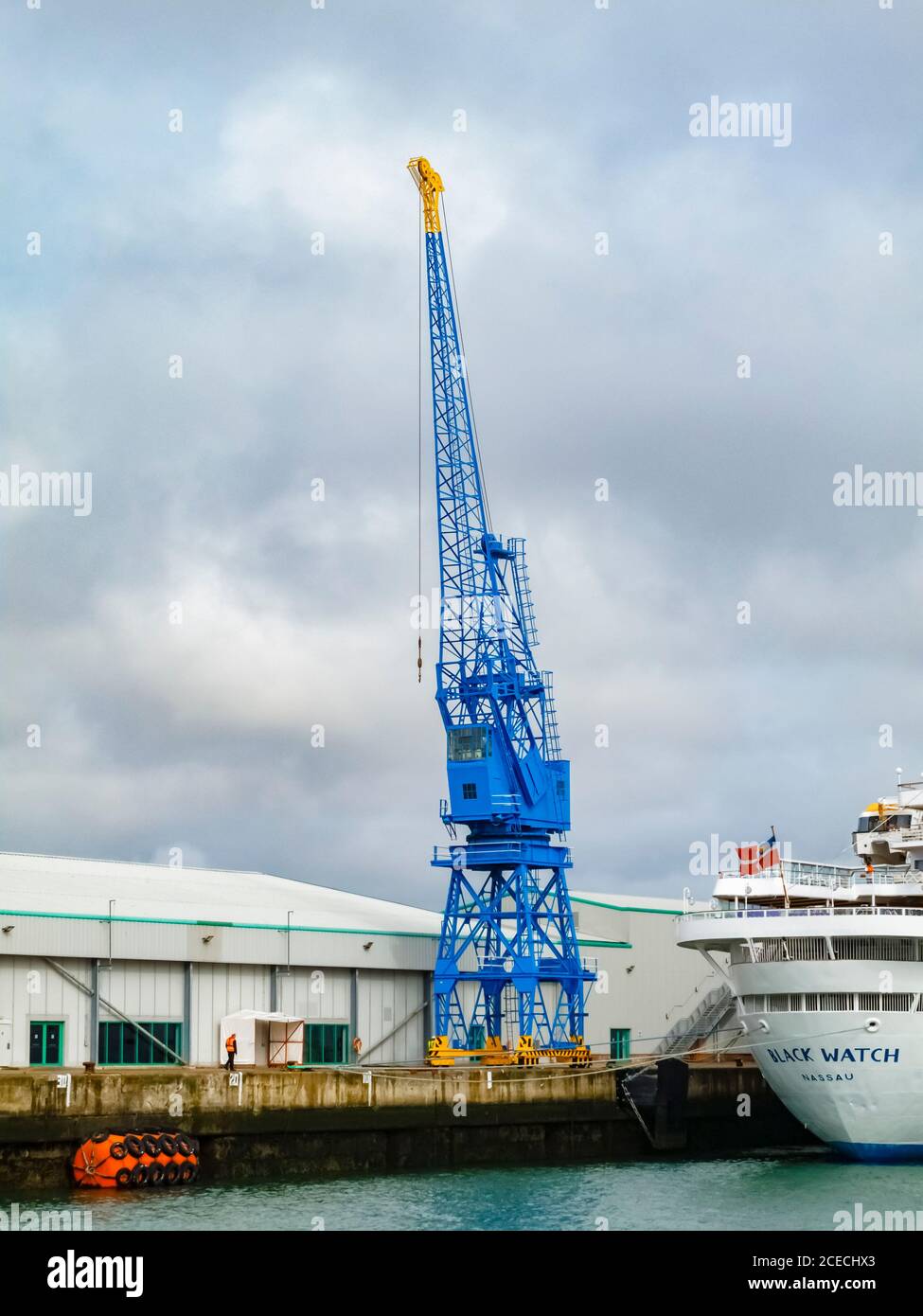 A blue moveable gantry crane on the waterside of the docks at the Port ...