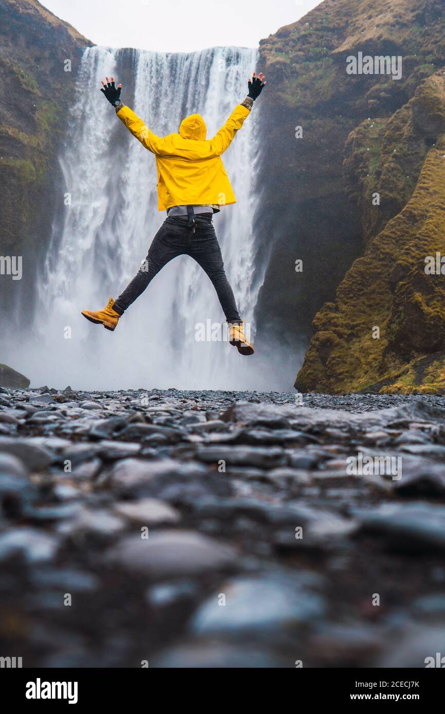 man jumping near waterfall Stock Photo - Alamy
