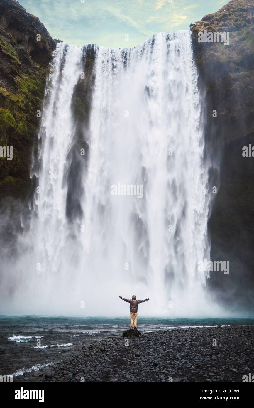 man standing near waterfall Stock Photo - Alamy