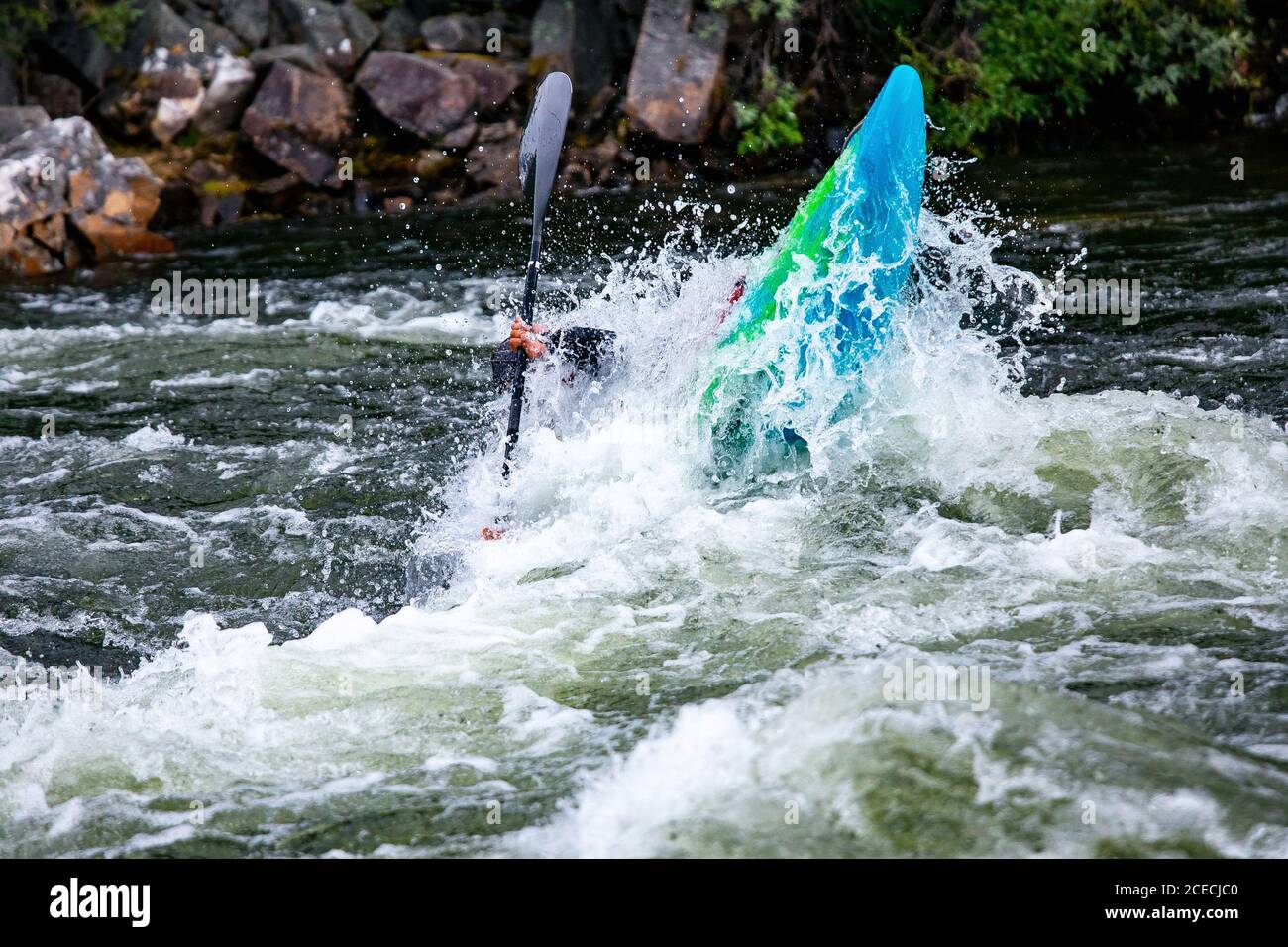 Guy in kayak sails mountain river. Whitewater kayaking, extreme sport ...