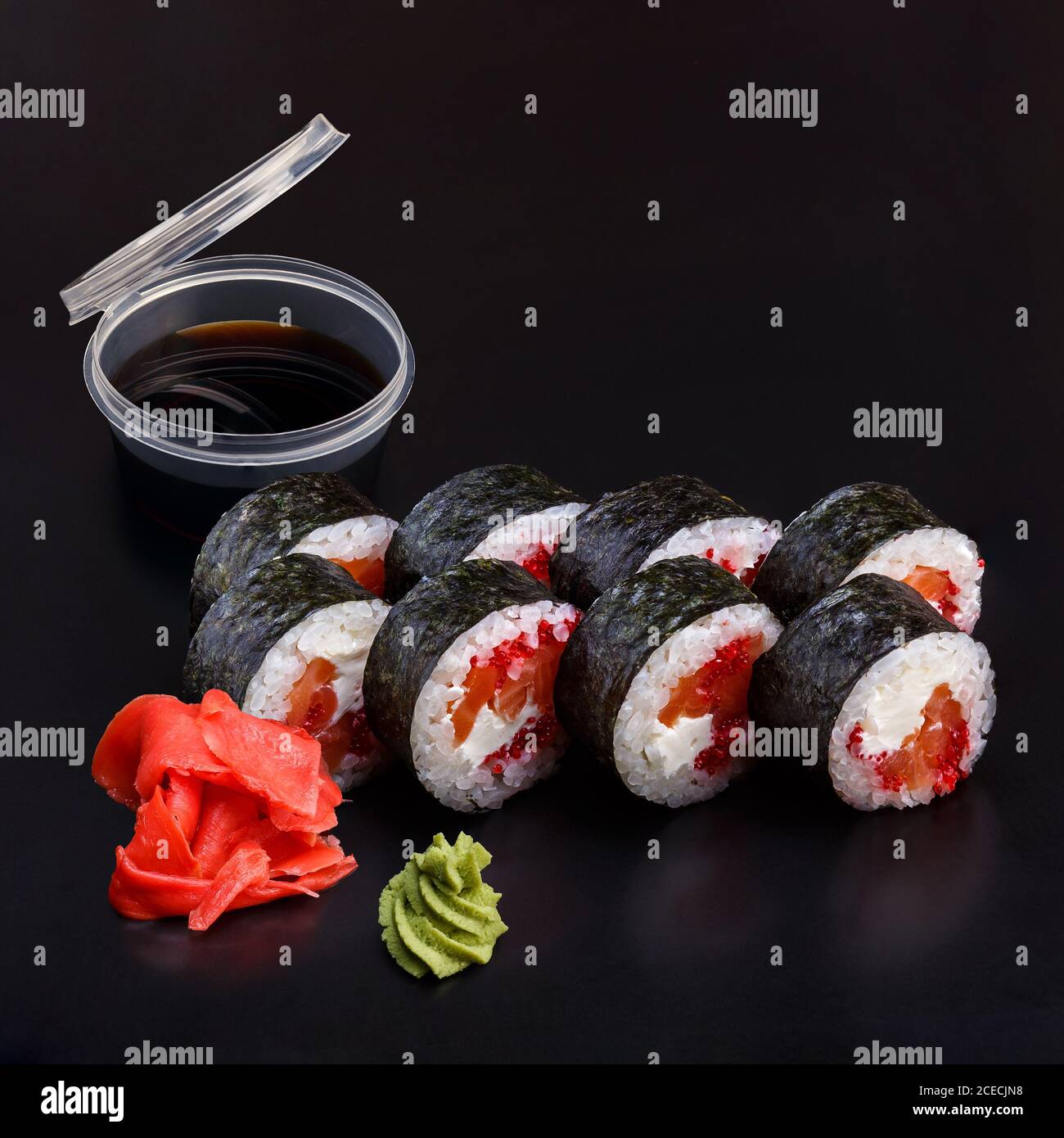 Traditional delicious fresh tobiko sake sushi roll set on a black ...