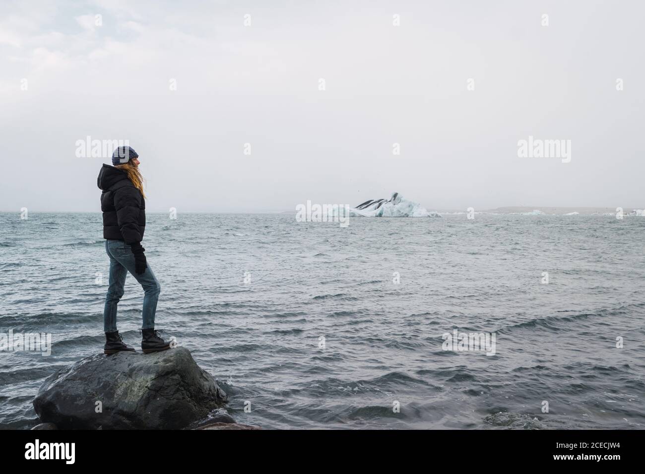 girl standing on rock in sea Stock Photo - Alamy