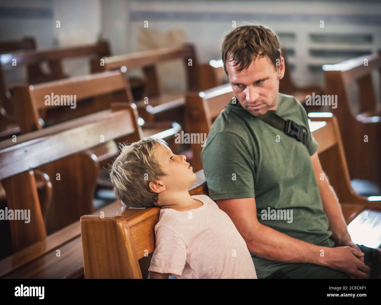 Christian dad tells his son Bible stories about Jesus sitting in kirk ...
