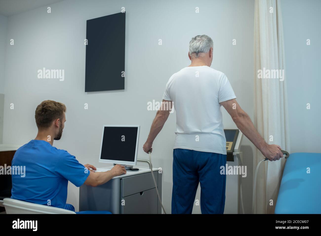 Doctor standing back hi-res stock photography and images - Alamy