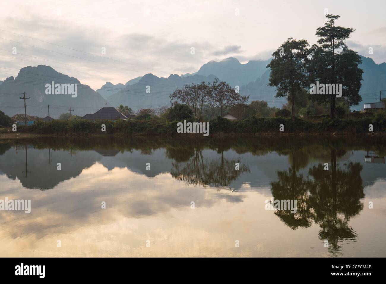 Landscape reflecting in river Stock Photo - Alamy
