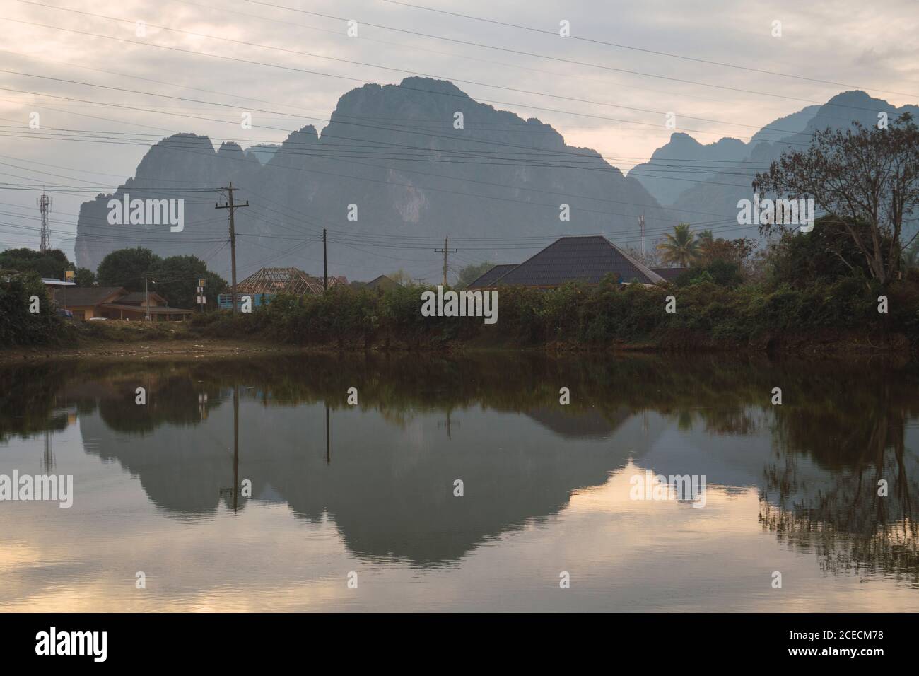 Landscape reflecting in river Stock Photo - Alamy