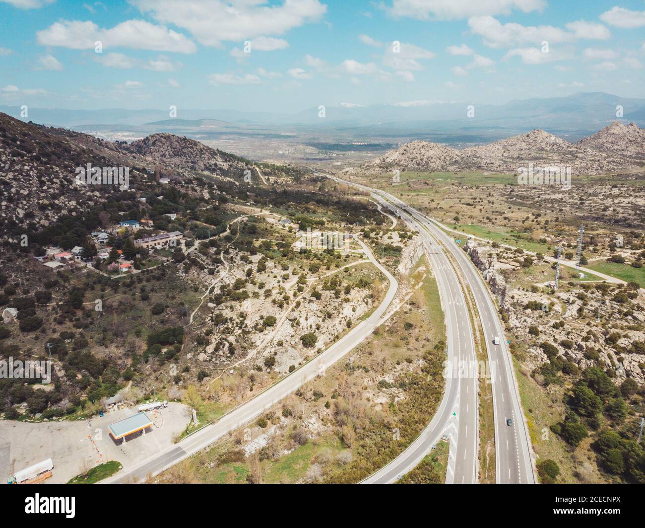Drone scenery of long way roads in deserted knolls with light blue ...