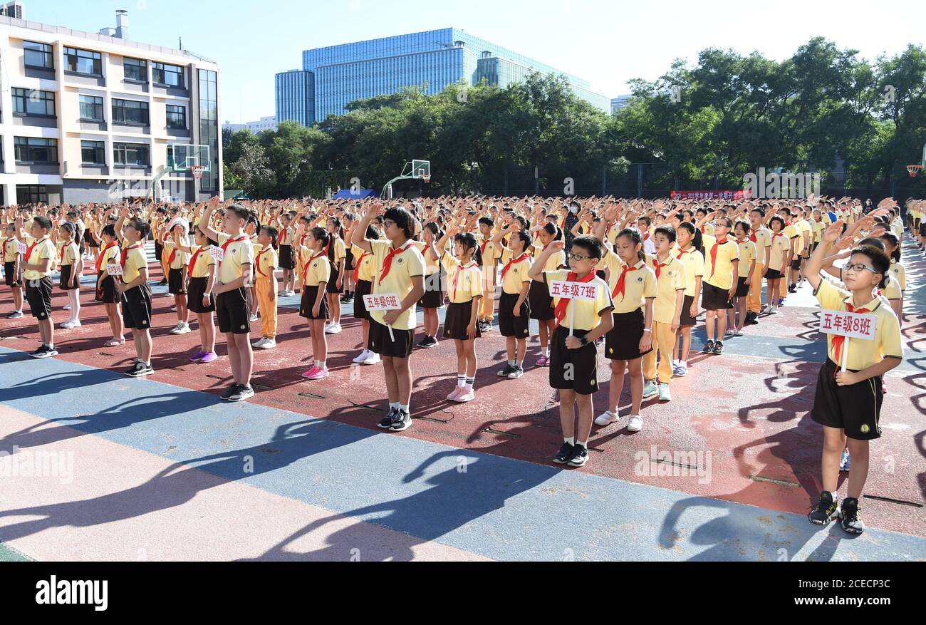 Beijing, China. 1st Sep, 2020. Students take part in a flag-raising ...