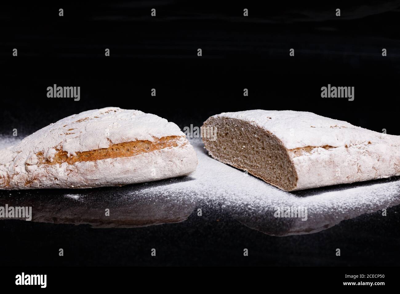 Gray bread sprinkled with flour. Homemade pastries, bread cut gavpil ...