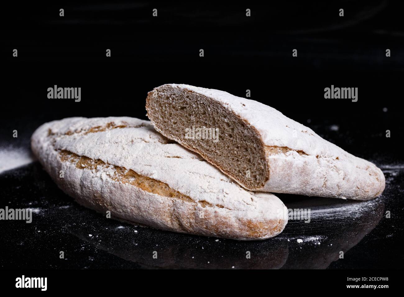 Gray bread sprinkled with flour. Homemade pastries, bread cut gavpil ...