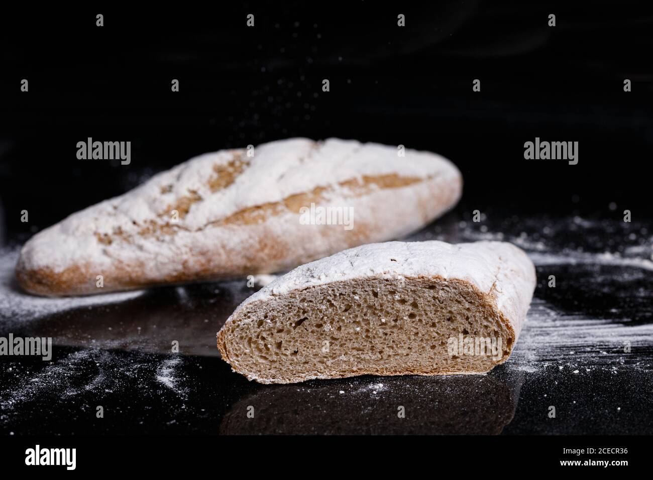 Gray bread sprinkled with flour. Homemade pastries, bread cut gavpil ...