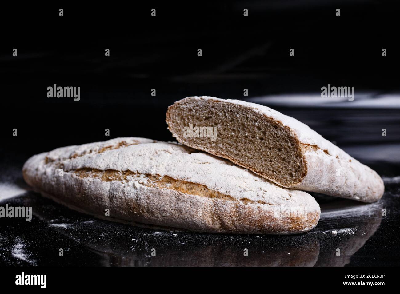 Gray bread sprinkled with flour. Homemade pastries, bread cut gavpil ...
