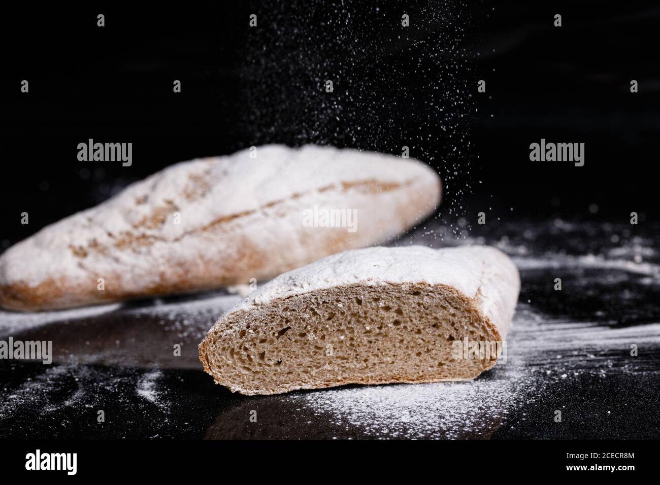Gray bread sprinkled with flour. Homemade pastries, bread cut gavpil ...