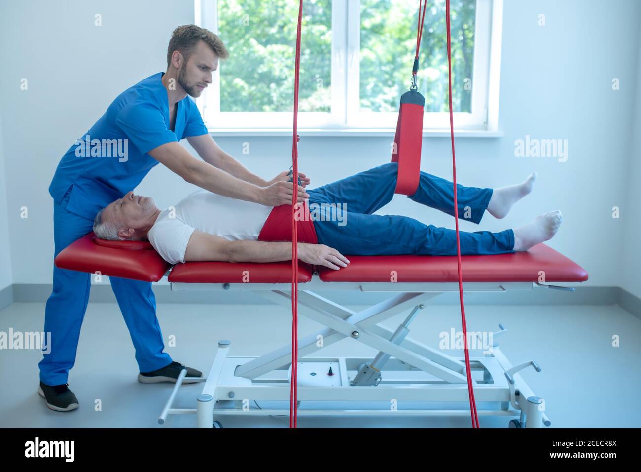 Attentive professional doctor rehabilitator and patient on special ...
