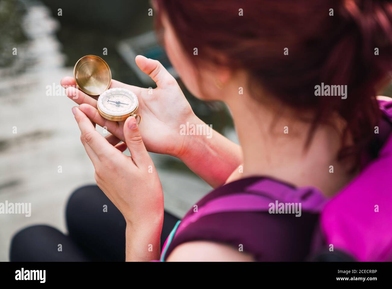 Woman looking compass in hi-res stock photography and images - Alamy