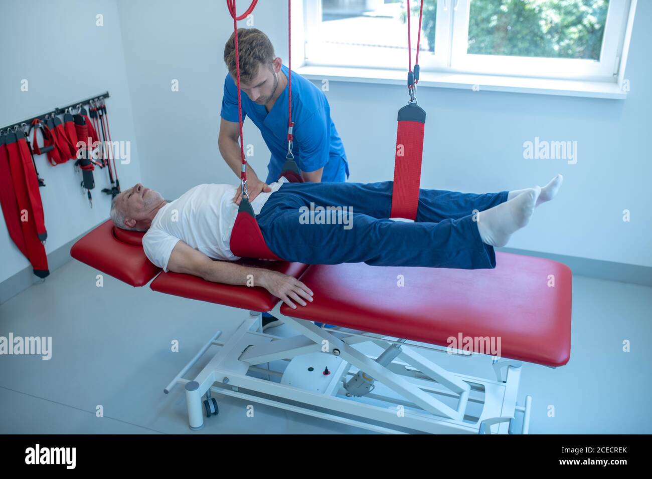 Male doctor and patient at physio procedure Stock Photo - Alamy