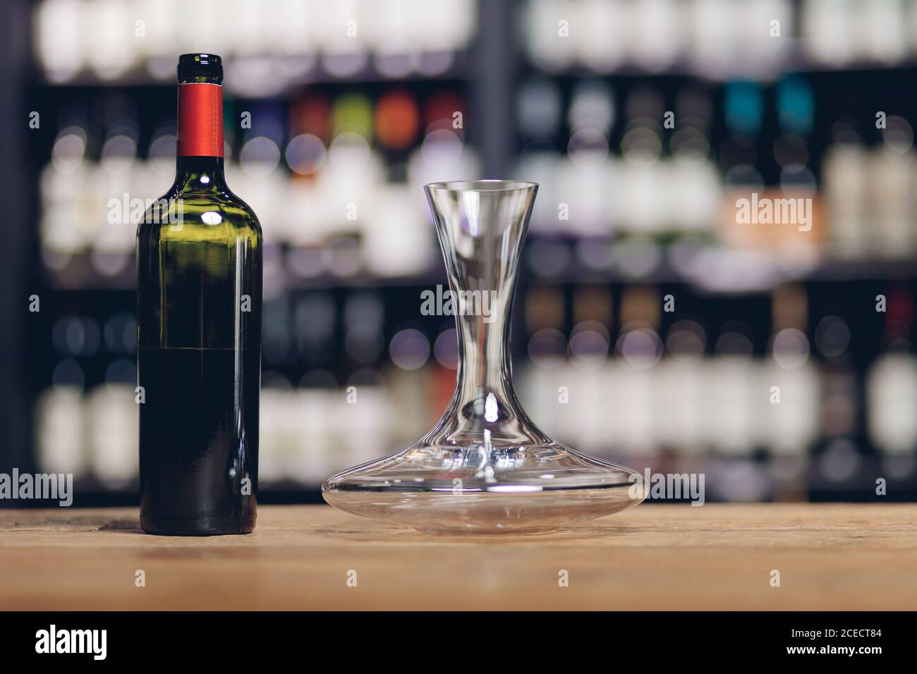 Glass and decanter red wine on wooden bar counter in restaurant, copy ...