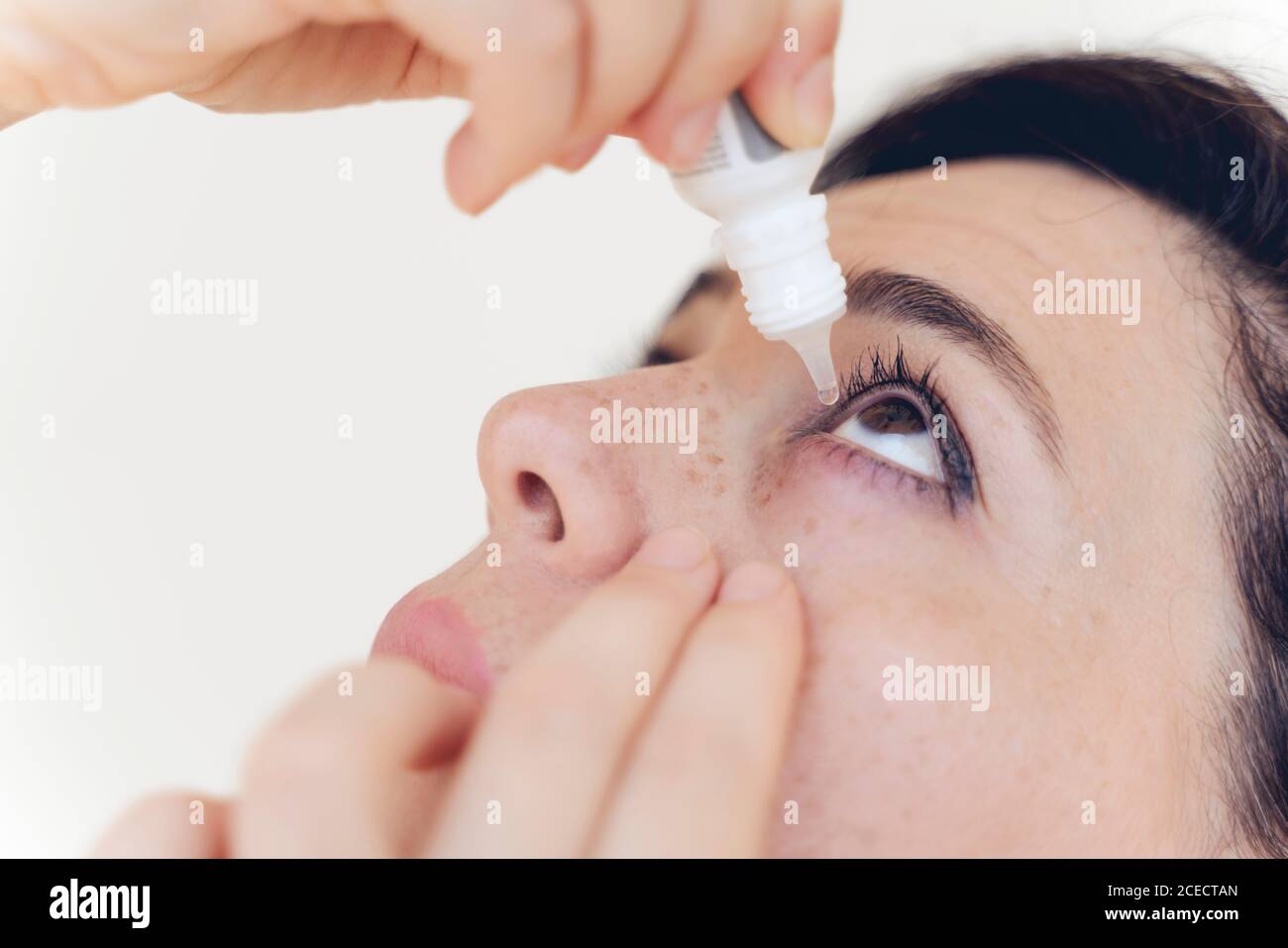 Woman Using Eye Drop Woman Dropping Eye Lubricant To Treat Dry Eye Or