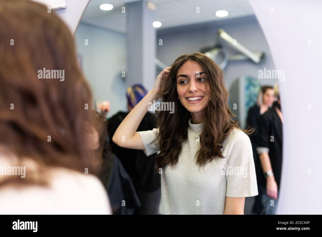 Attractive lady looking in mirror hi-res stock photography and images ...