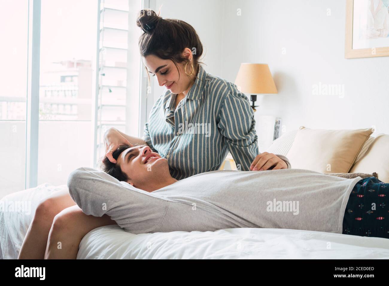 Woman lying on bed knees hi-res stock photography and images - Alamy