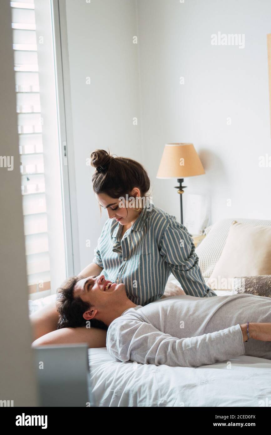 Happy couple on bed Stock Photo - Alamy