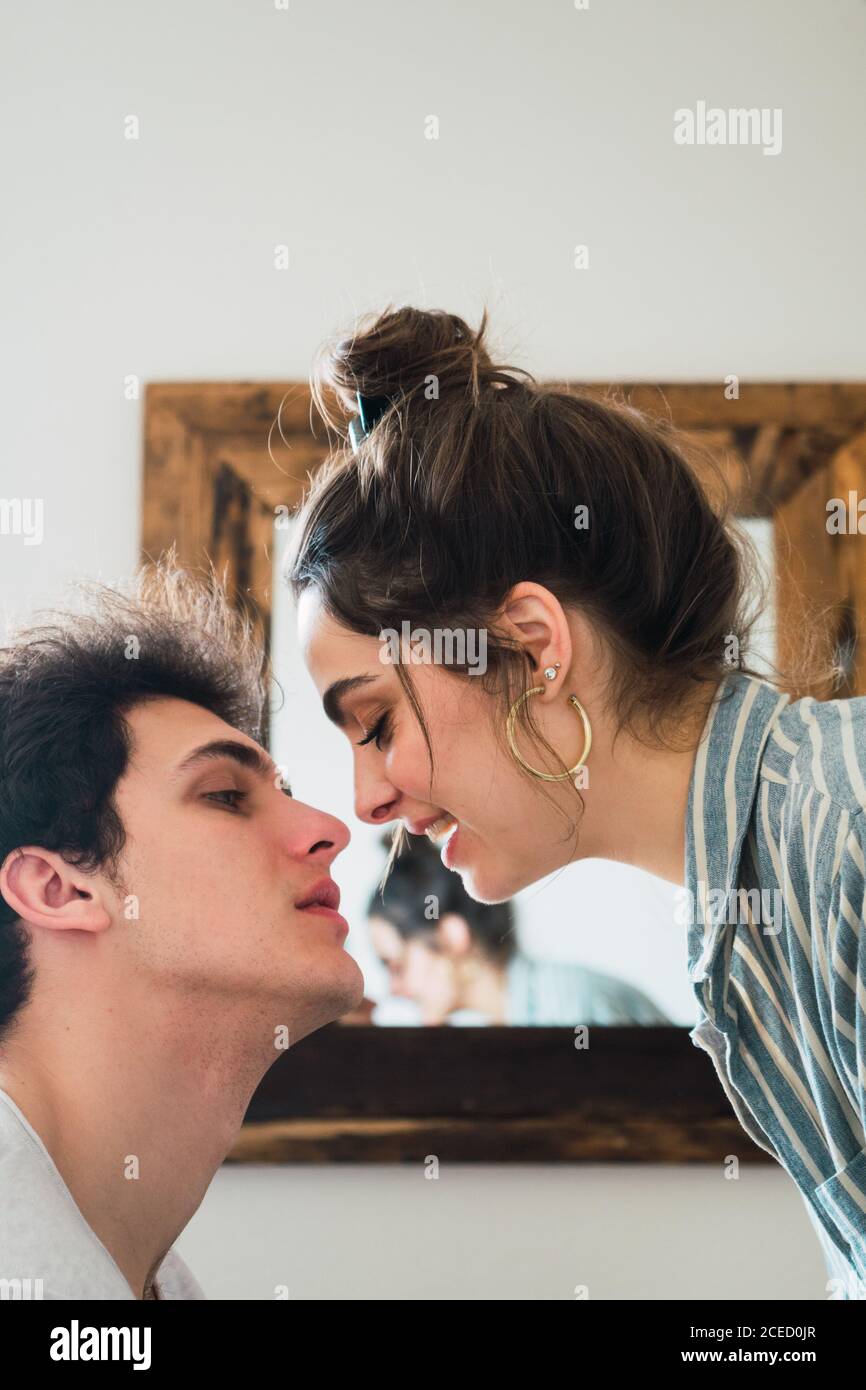 Couple kissing at table Stock Photo - Alamy