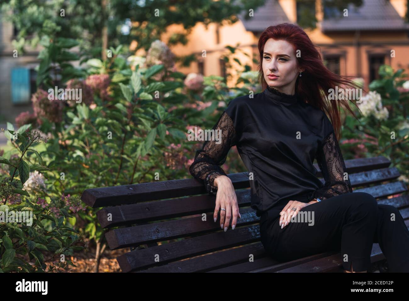 Beautiful lady sitting on bench Stock Photo - Alamy