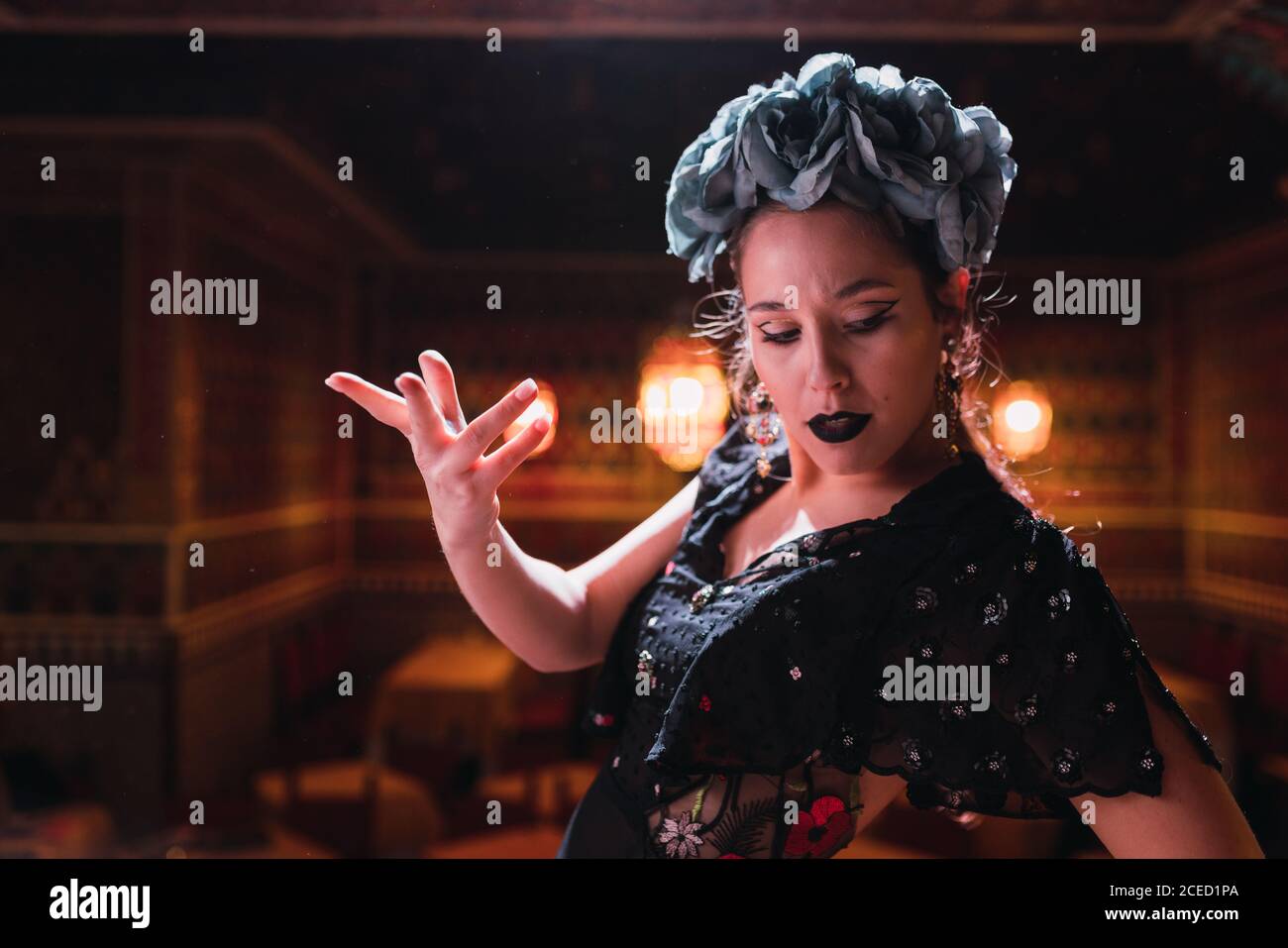 Young lady in dress dancing flamenco on scene in luxury oriental room ...