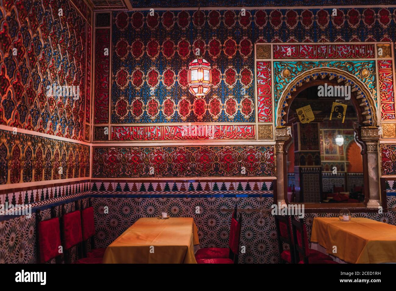 Wonderful room of cafe with tables and chairs and walls decorated by ...