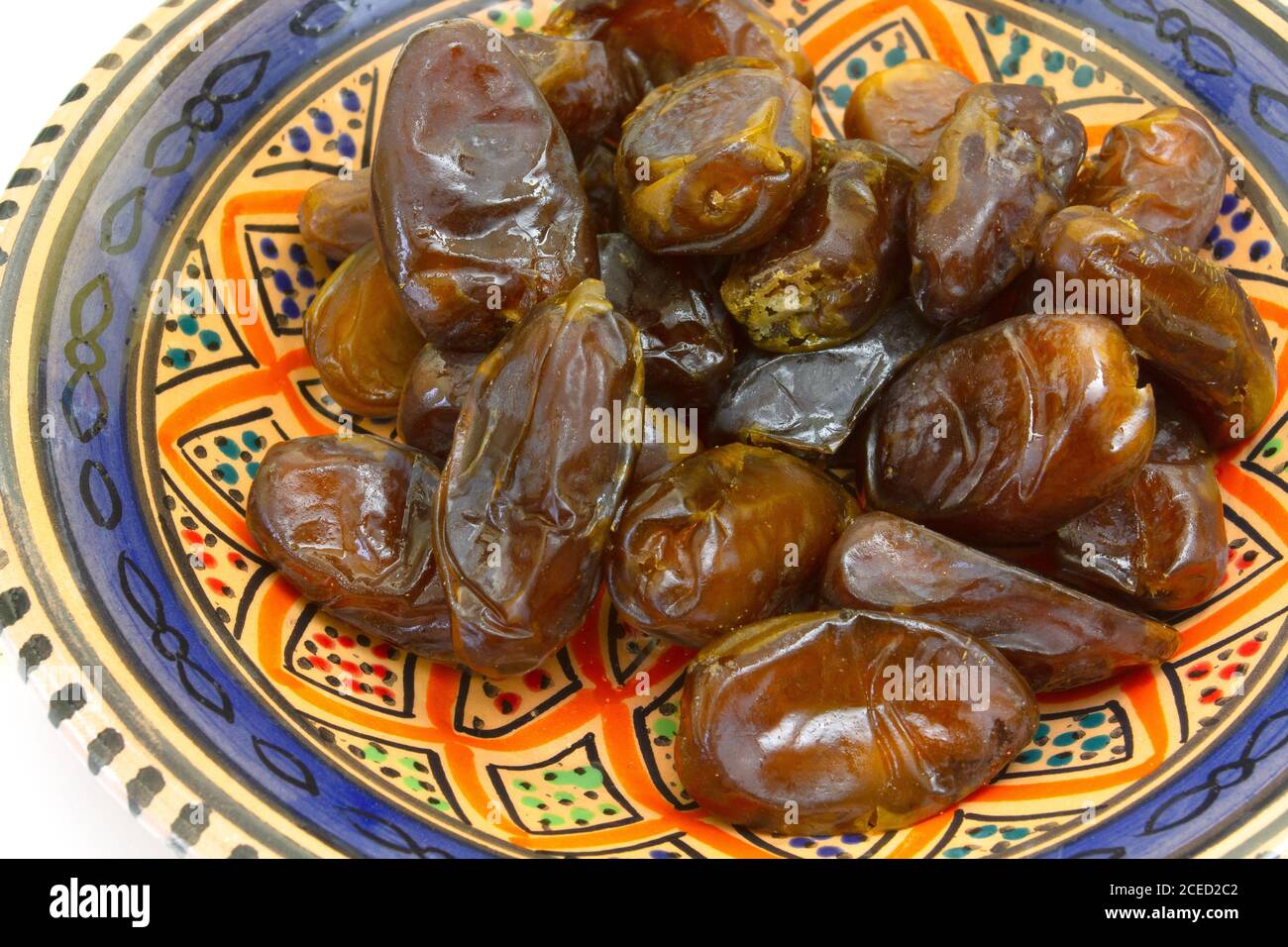 pile of dates isolated on a white background Stock Photo - Alamy