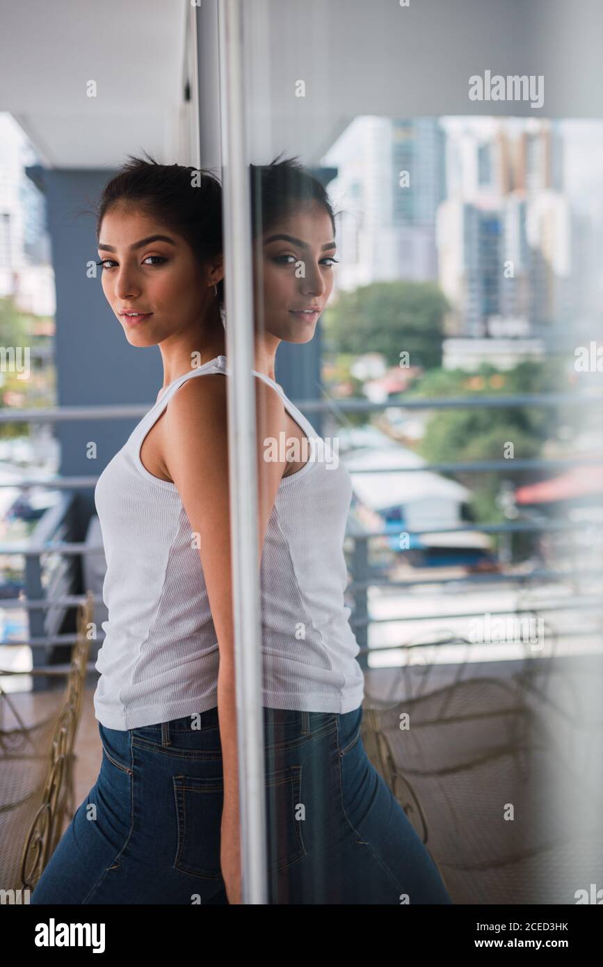 Beautiful brunette thoughtful Hispanic Woman in casual wear standing ...